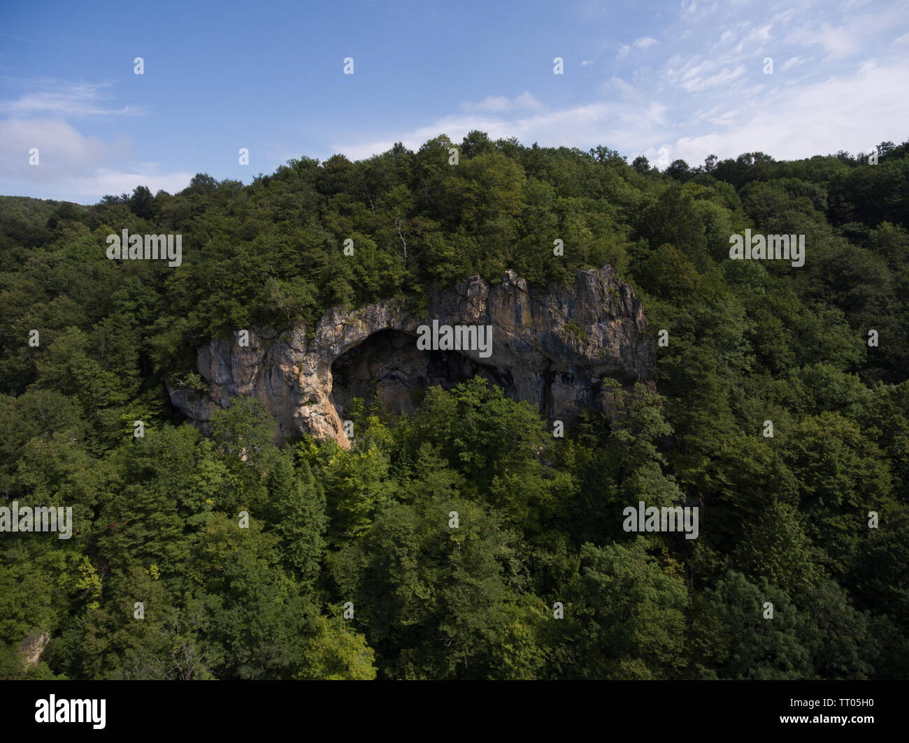 Aerial Photos. The cave entrance is emblazoned on the side of a ...