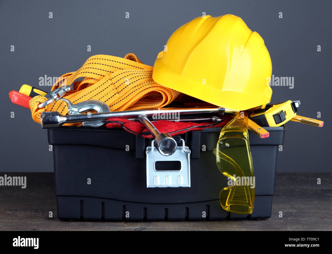 Black toolbox with tools on wooden table on grey background Stock Photo ...