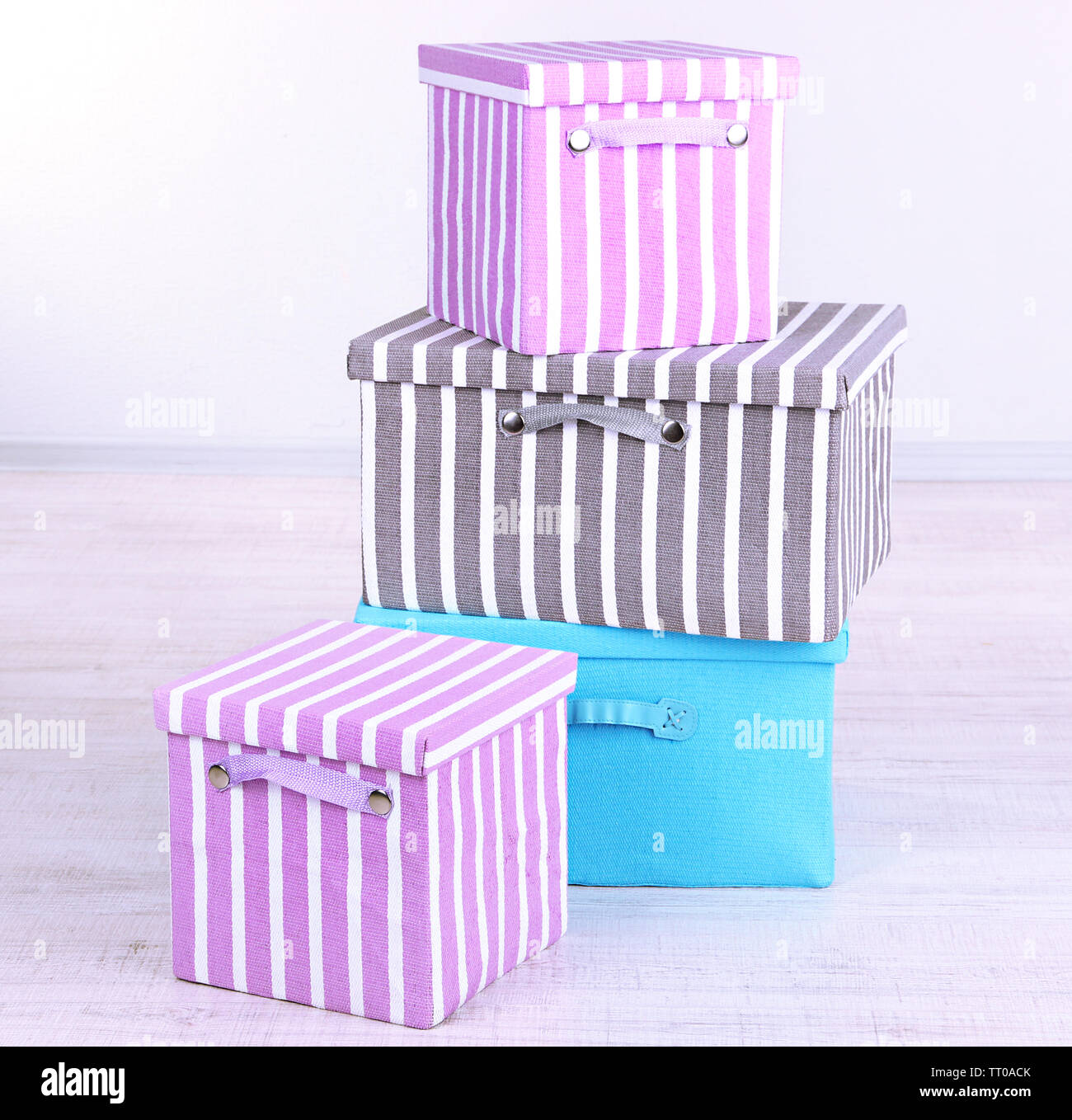 Textile boxes on floor in room Stock Photo - Alamy
