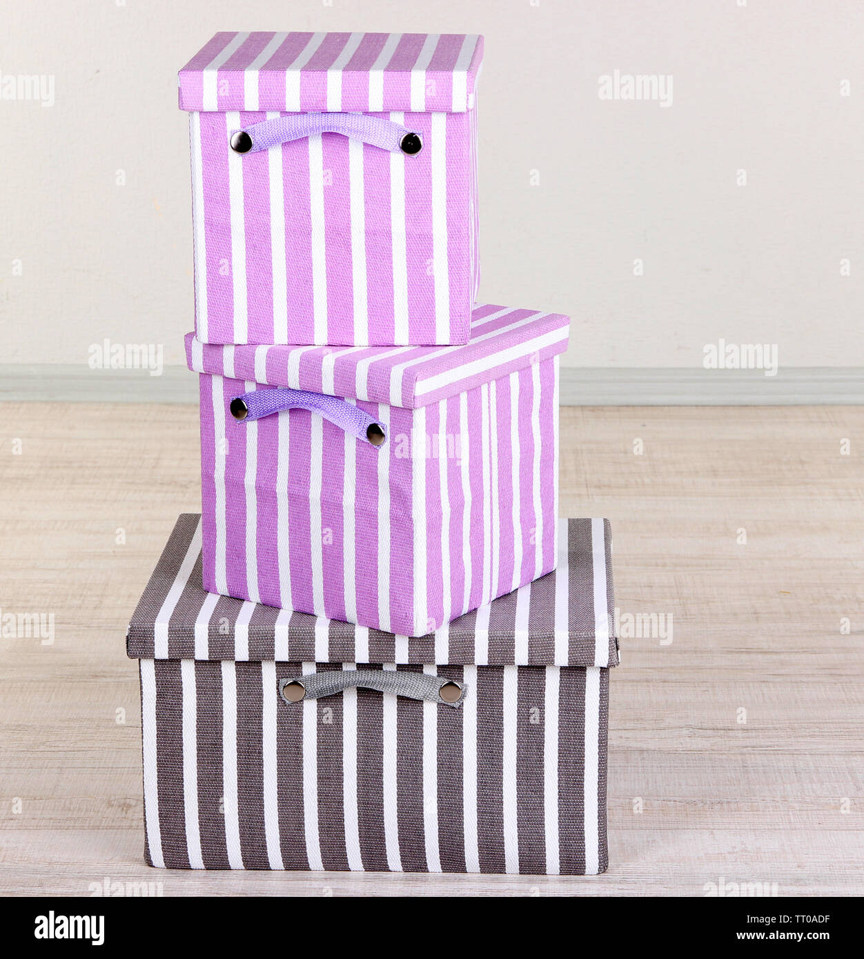 Textile boxes on floor in room Stock Photo - Alamy
