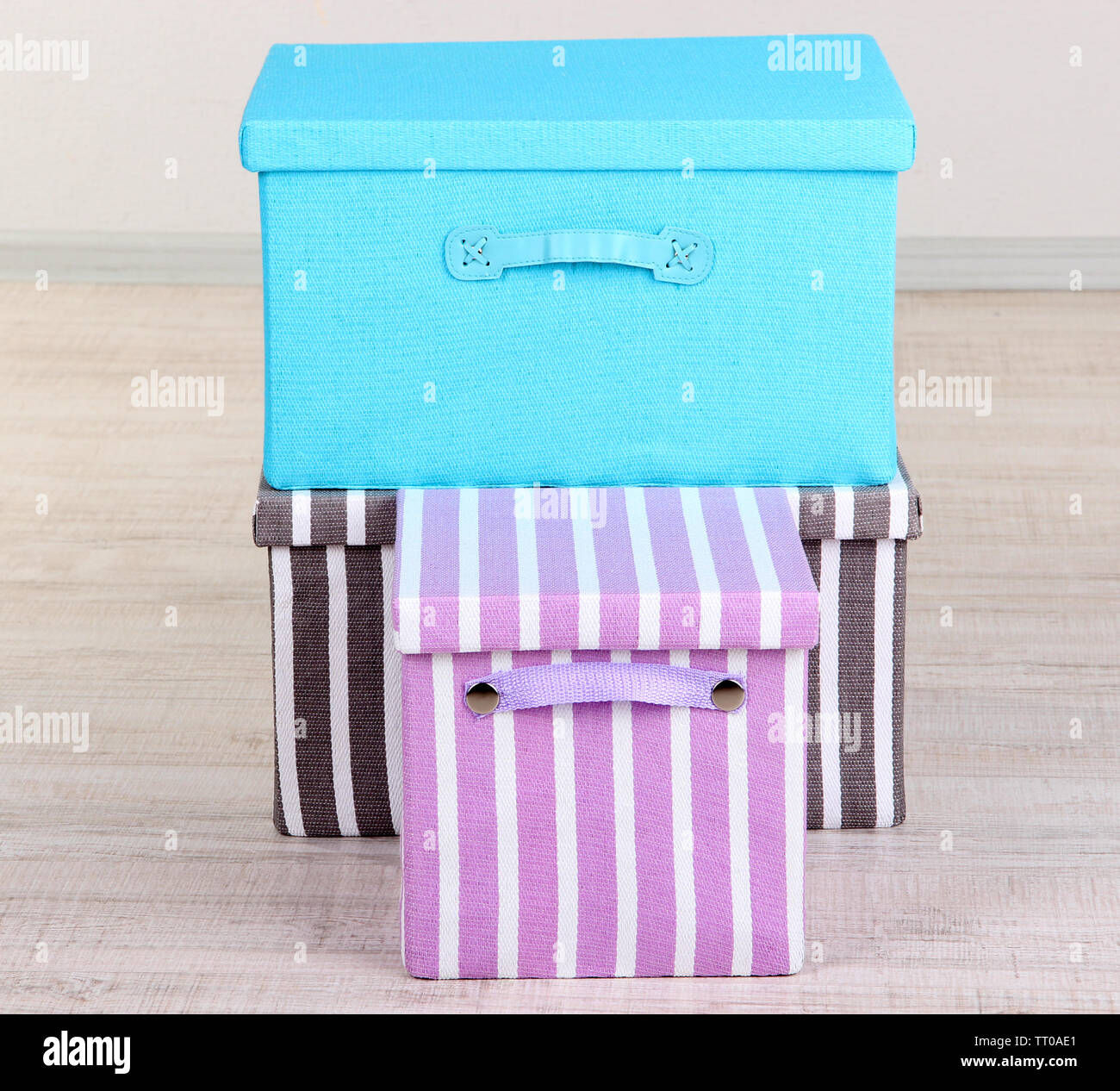 Textile boxes on floor in room Stock Photo - Alamy