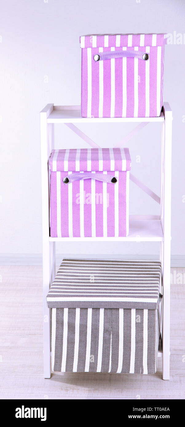 Textile boxes on shelf in room Stock Photo - Alamy