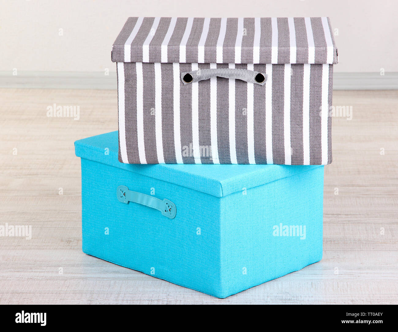 Textile boxes on floor in room Stock Photo - Alamy