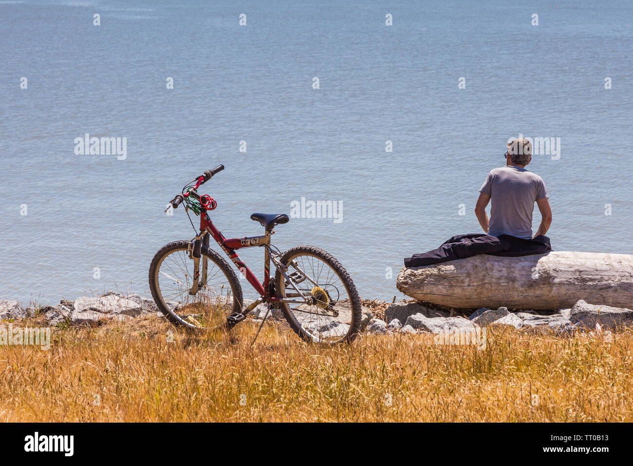 Bike rider resting on bicycle hi-res stock photography and images - Alamy