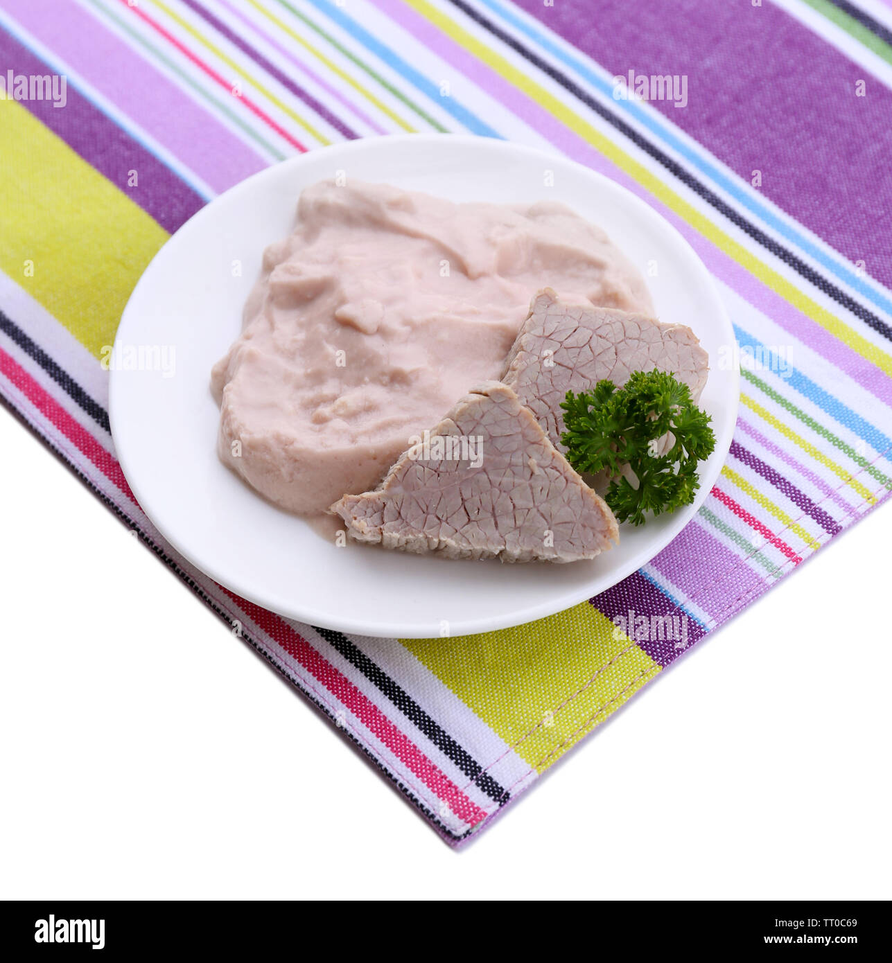 Meat paste for infant feeding, on plate, on color napkin, isolated on ...
