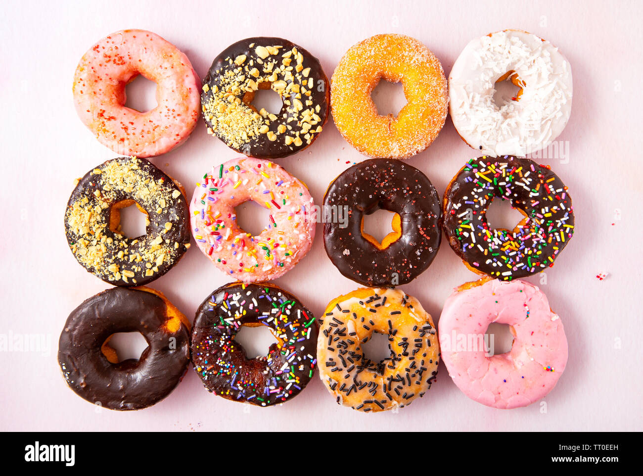 Overhead view of a dozen freshly baked doughnuts Stock Photo - Alamy