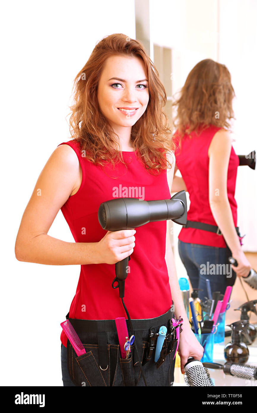 Beautiful girl hairdresser in beauty salon Stock Photo - Alamy