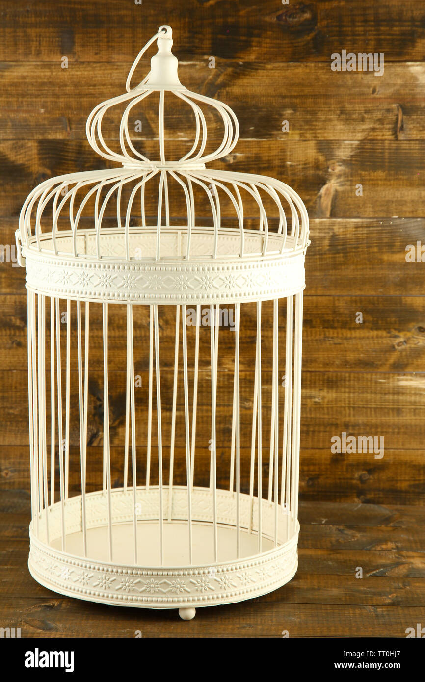 Beautiful decorative cage, on wooden background Stock Photo - Alamy