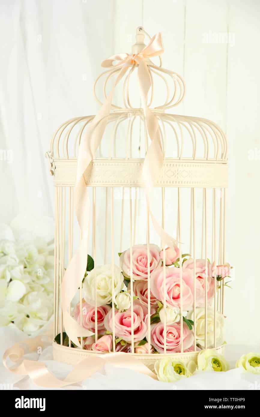 Beautiful decorative cage with beautiful flowers Stock Photo - Alamy