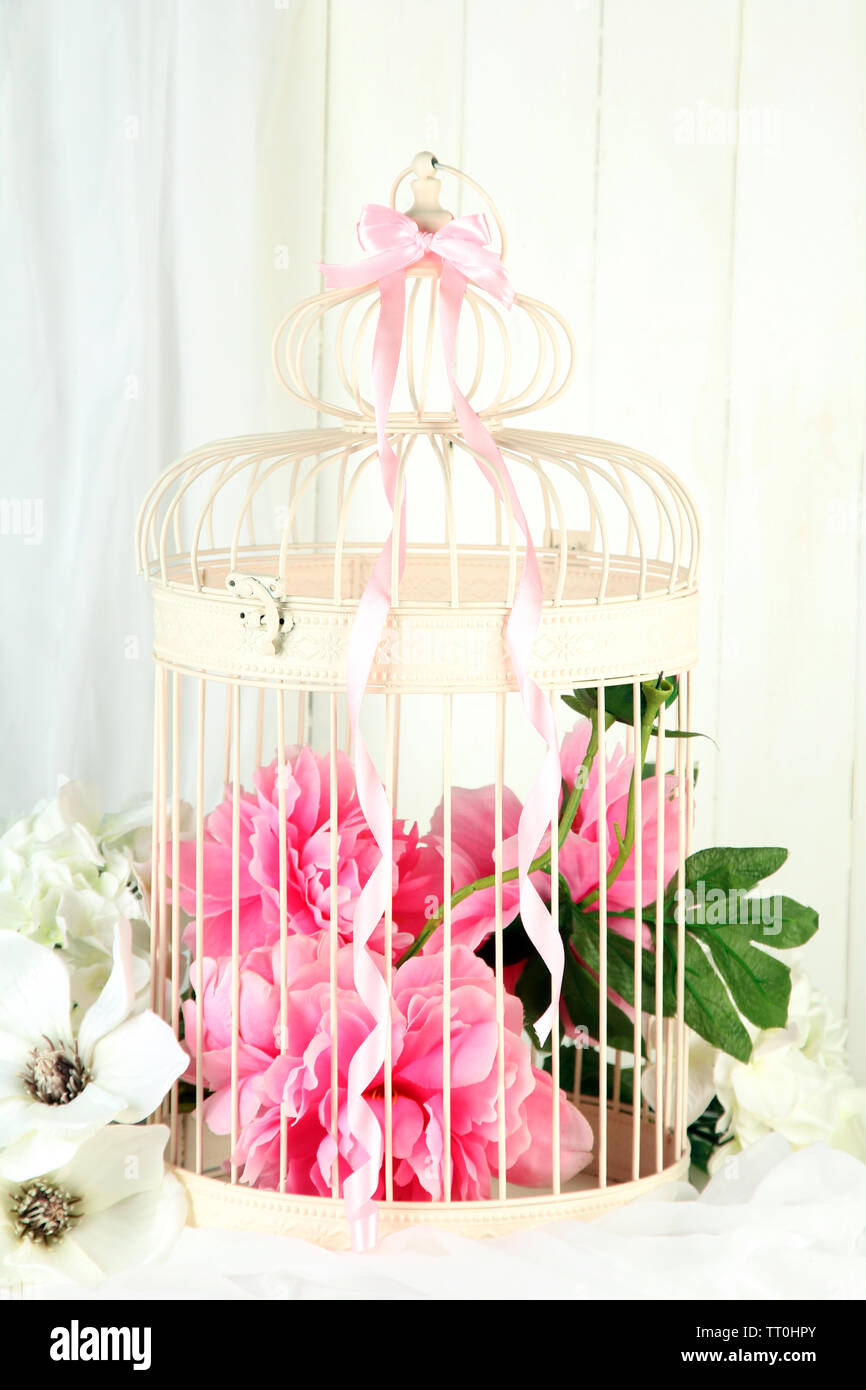 Beautiful decorative cage with beautiful flowers Stock Photo - Alamy