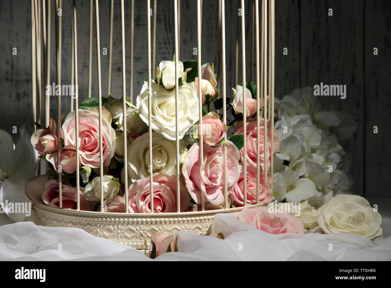 Beautiful decorative cage with beautiful flowers Stock Photo - Alamy