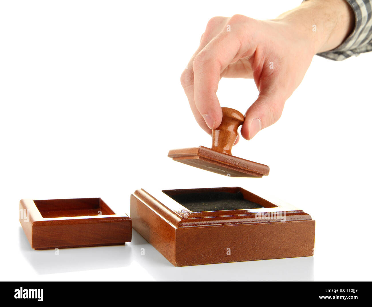 Hand holding wooden stamp isolated on white Stock Photo - Alamy