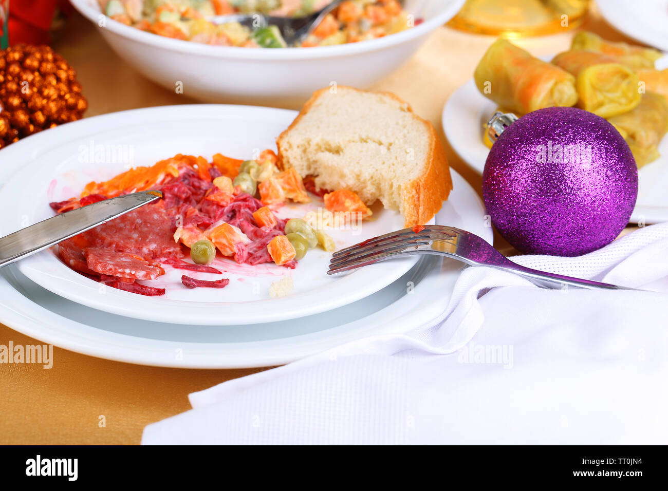 Table with festive dishes after feast close-up Stock Photo - Alamy
