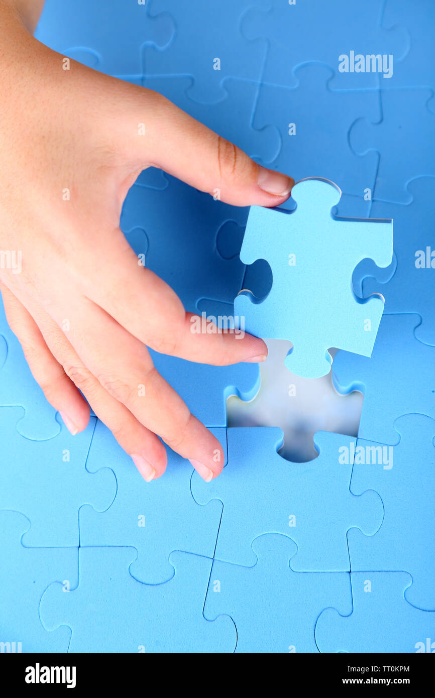 Last piece of jigsaw puzzle, close-up Stock Photo - Alamy