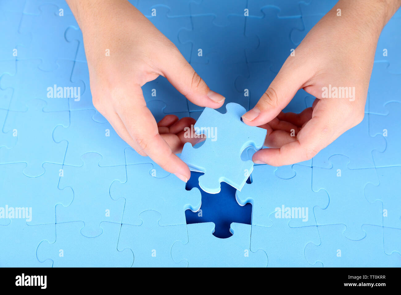 Hand holding puzzle piece, close up Stock Photo - Alamy