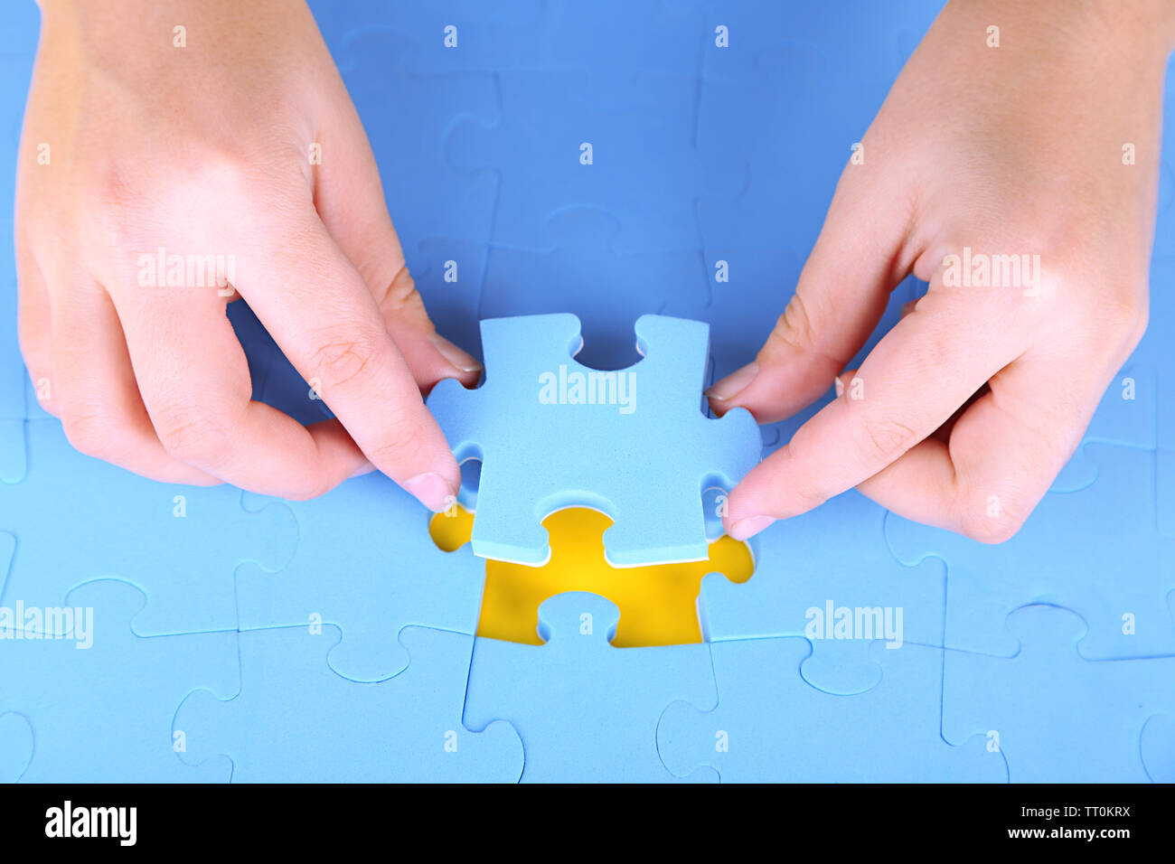 Hand holding puzzle piece, close up Stock Photo - Alamy