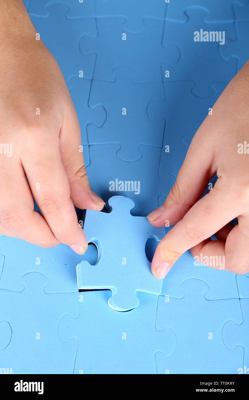 Hand holding puzzle piece, close up Stock Photo - Alamy