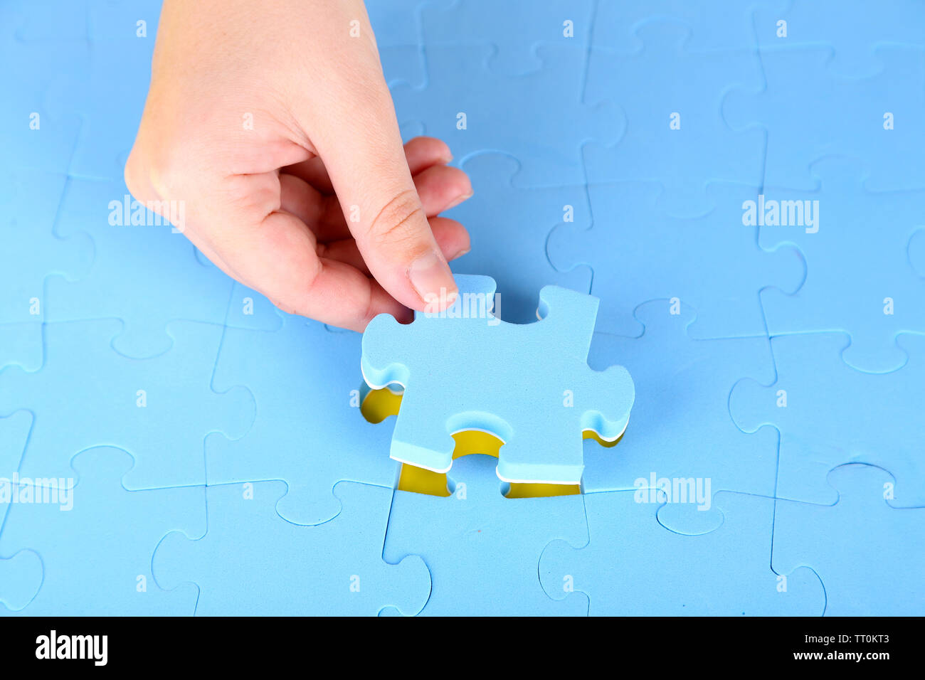 Hand holding puzzle piece, close up Stock Photo - Alamy