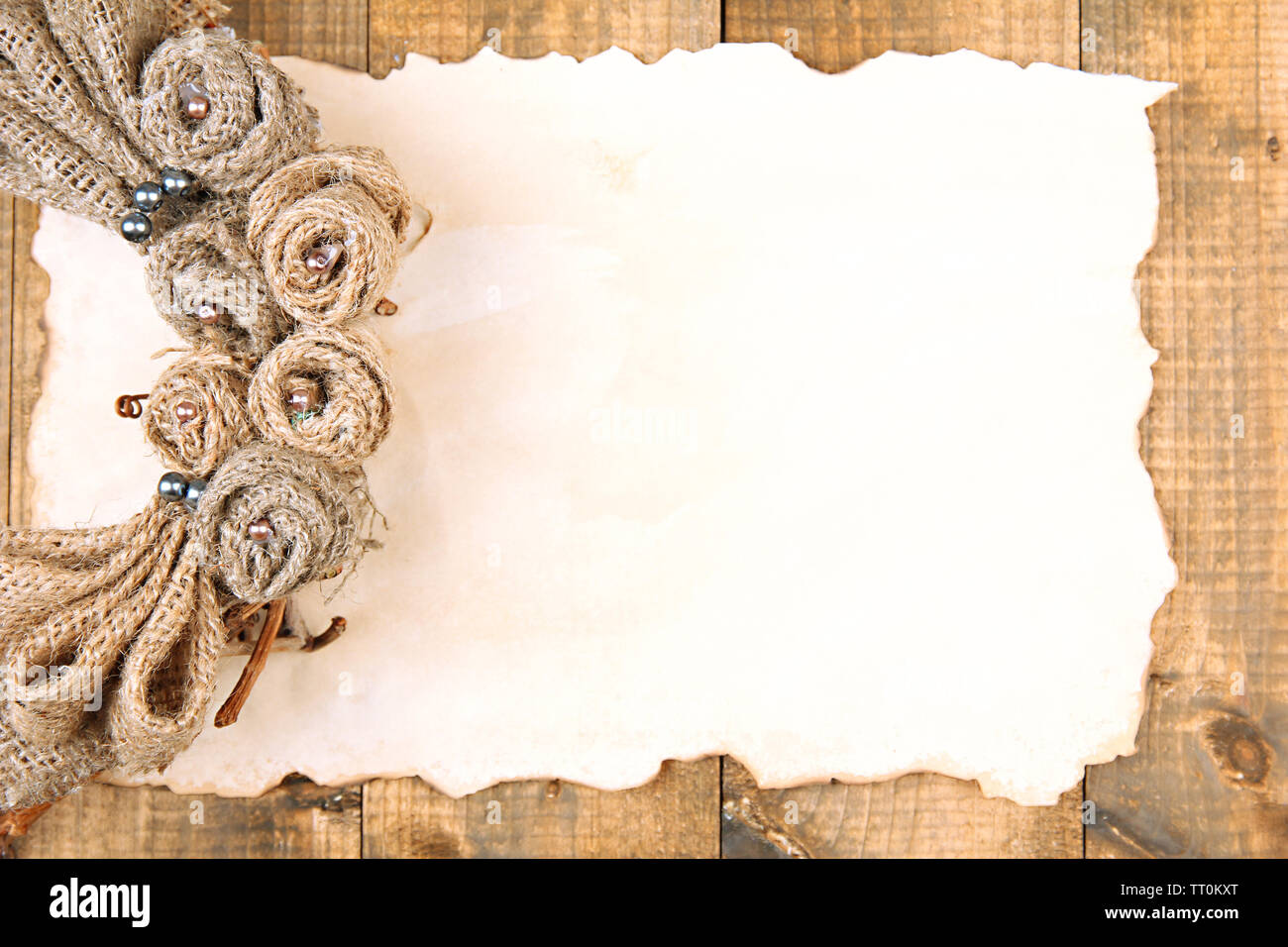 Old paper sheet and beautiful rustic wreath, on wooden background Stock ...