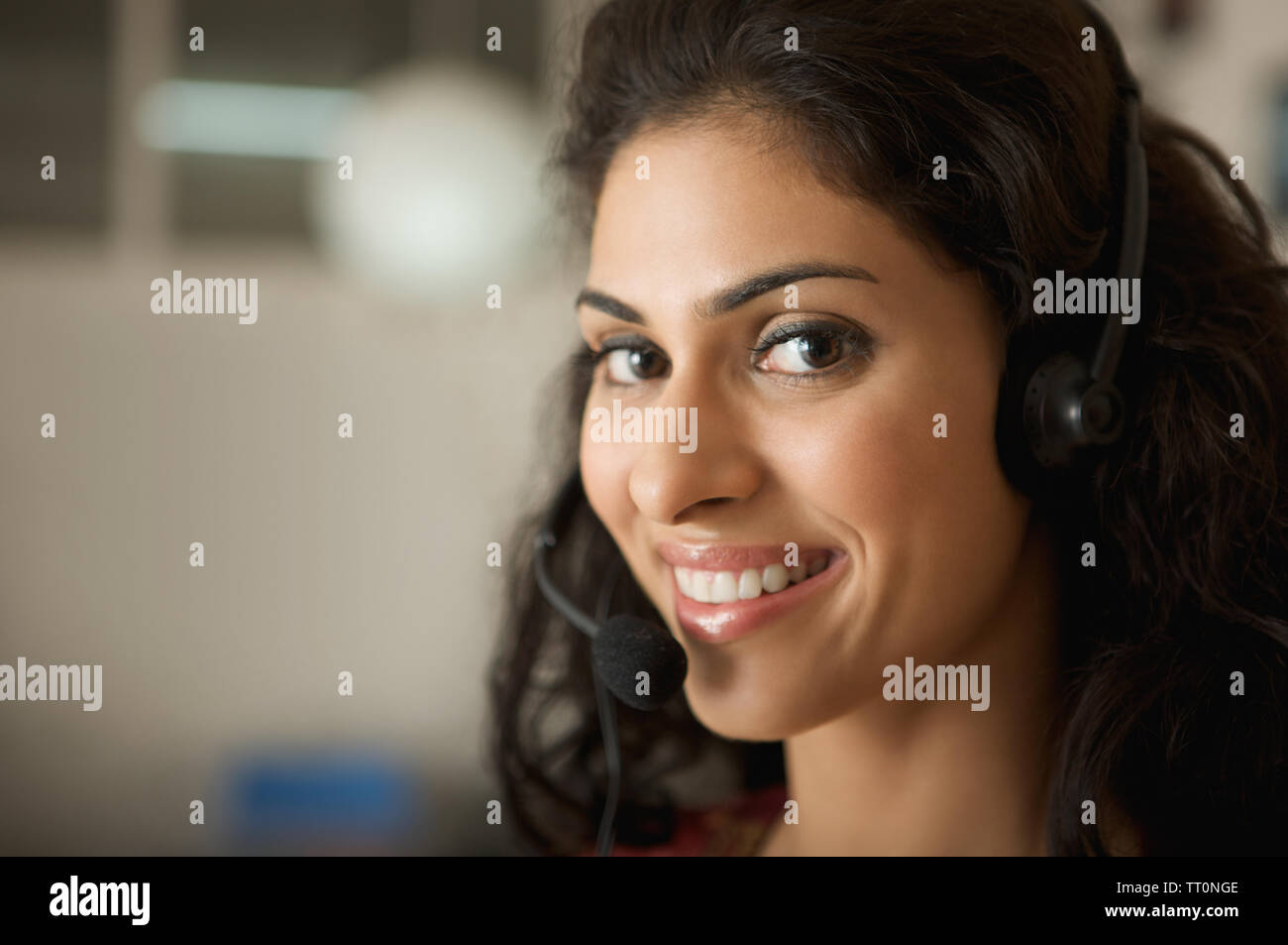 Indian young woman wearing a headset Stock Photo - Alamy