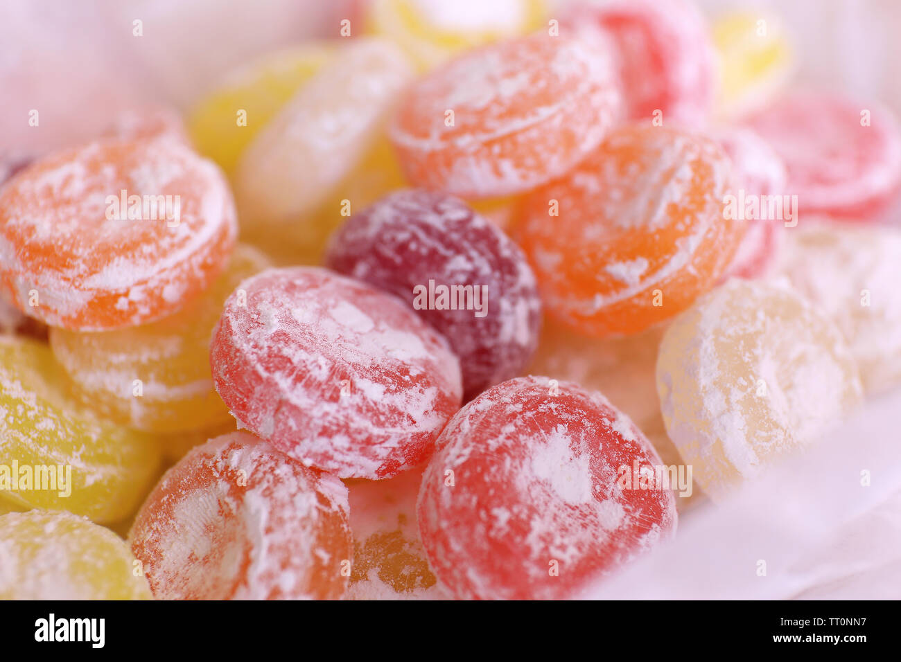 Sweet multicolor candies on paper, close up Stock Photo - Alamy