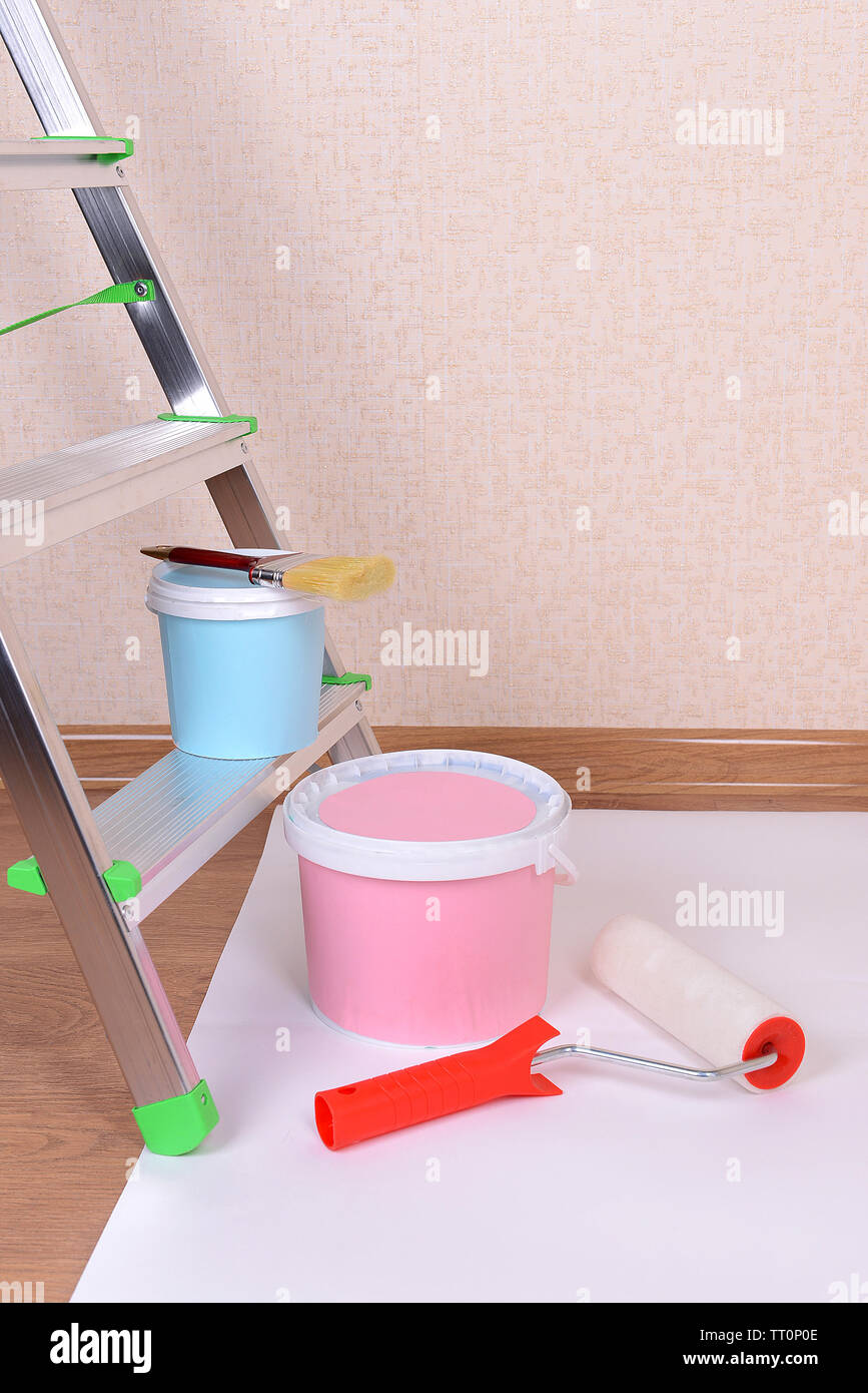 Metal ladder and paint in room Stock Photo - Alamy