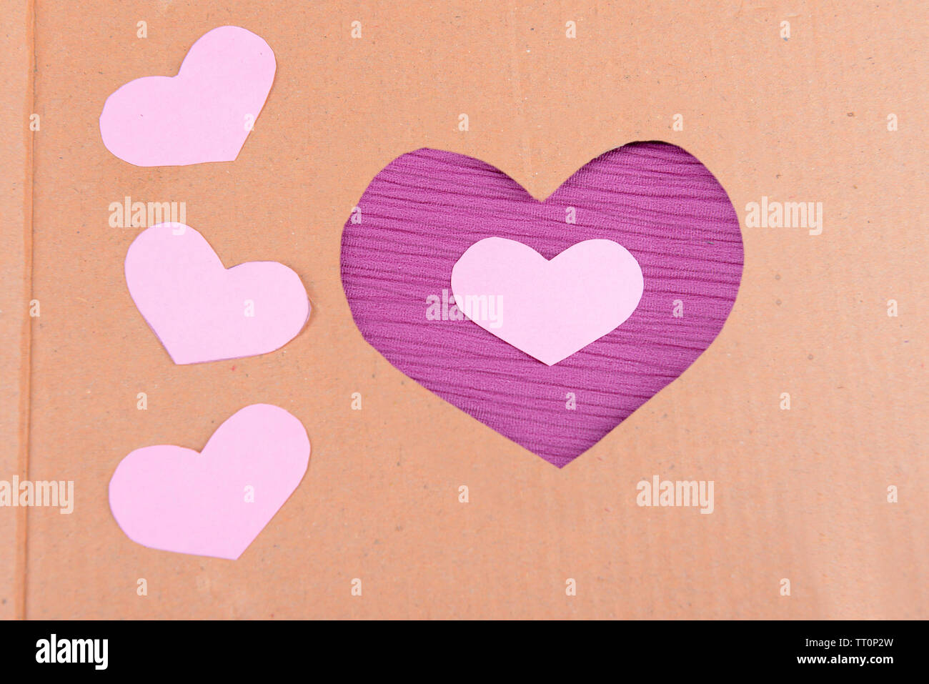 Cardboard heart on purple background Stock Photo - Alamy