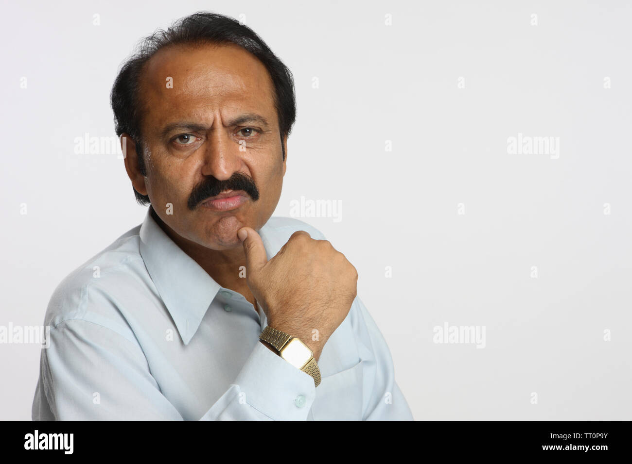 Portrait of an Indian man thinking Stock Photo - Alamy