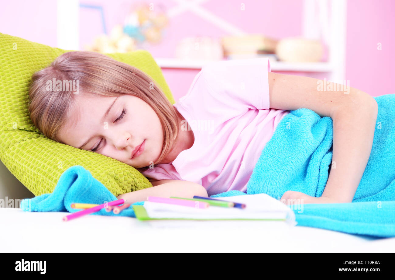 Little girl sleeping on sofa in room Stock Photo - Alamy