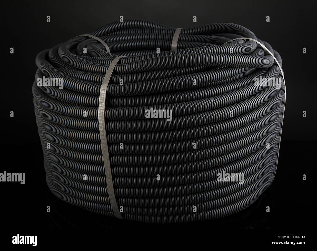 Black cable on black background Stock Photo - Alamy