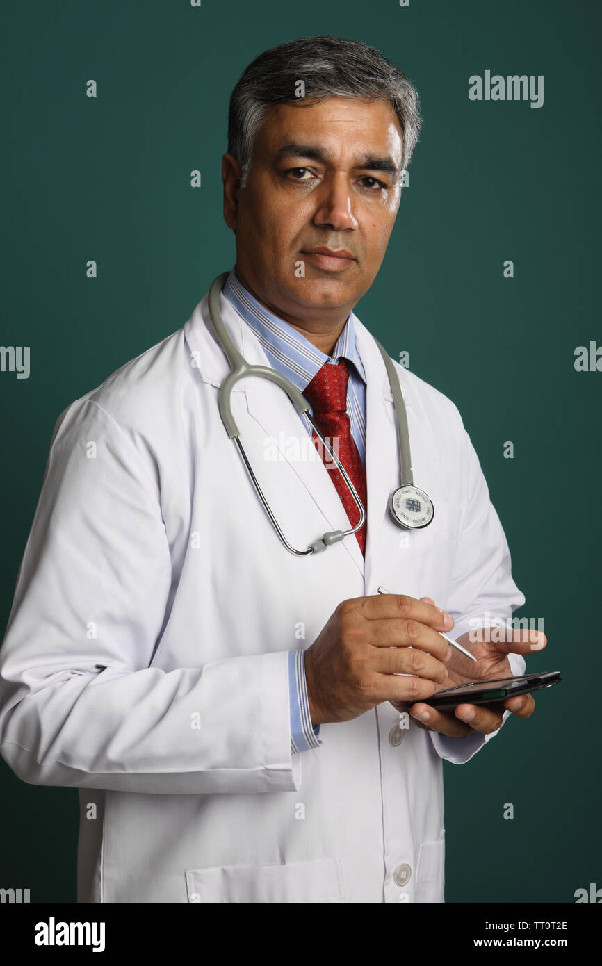 Indian male doctor using mobile hi-res stock photography and images - Alamy