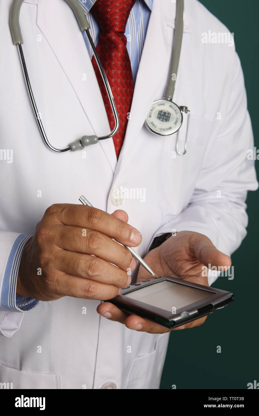 Mid section view of a male doctor using a pda Stock Photo - Alamy