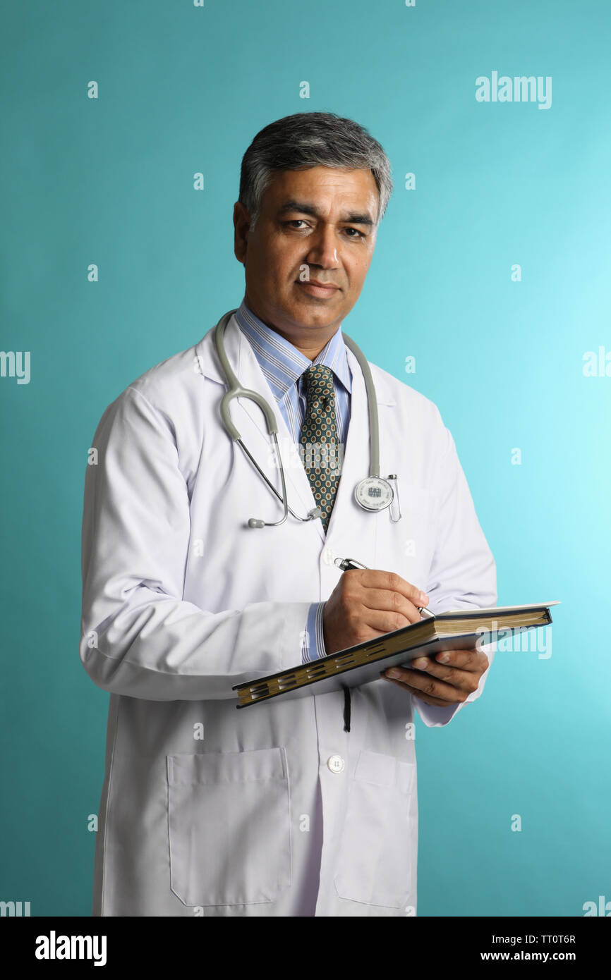 Doctor writing medical prescription elderly hi-res stock photography ...