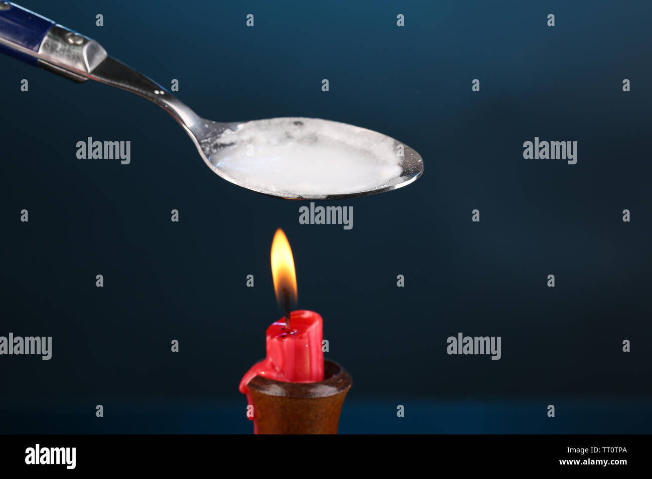 Heroin in spoon on dark blue background Stock Photo - Alamy