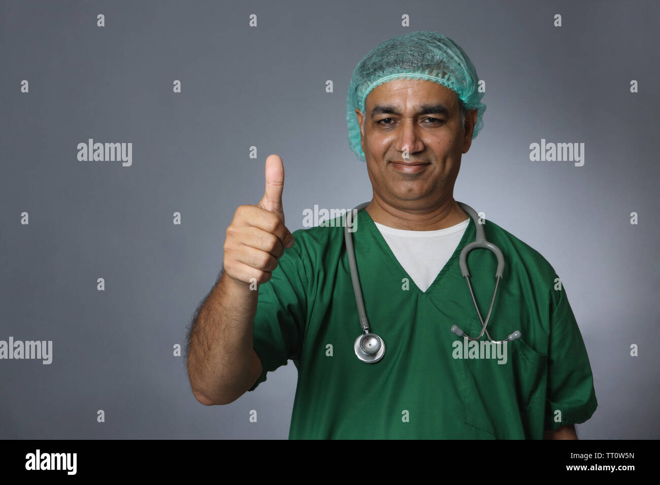 Portrait of a male surgeon showing thumbs up sign Stock Photo - Alamy