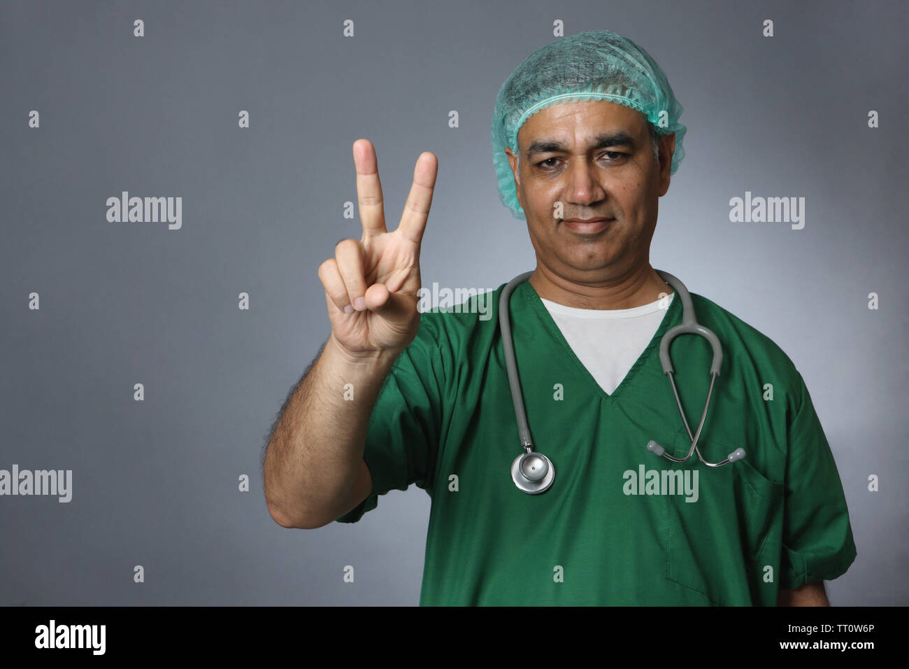 Portrait of a male surgeon showing a victory sign Stock Photo - Alamy