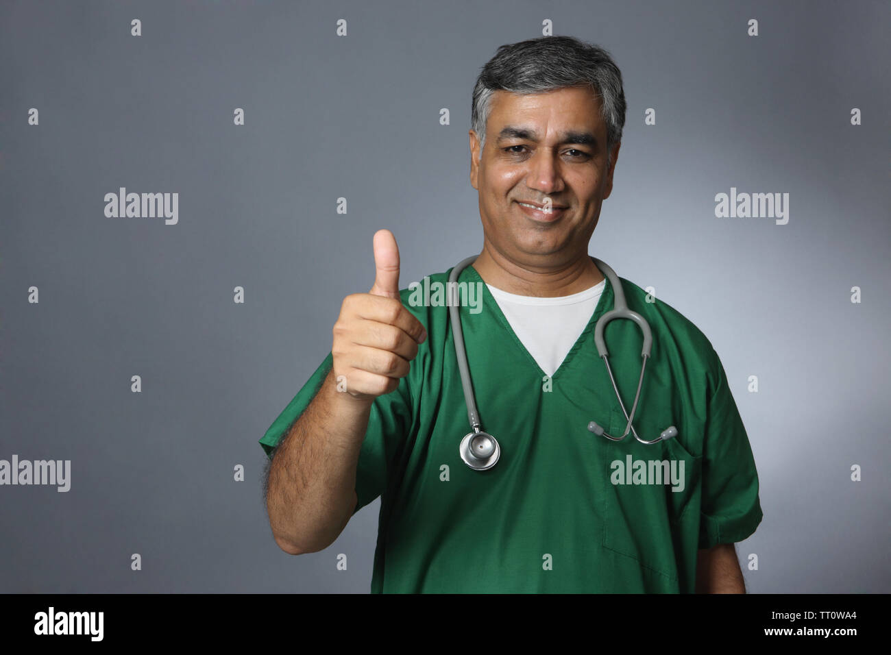 Portrait of a male surgeon showing thumbs up sign Stock Photo - Alamy