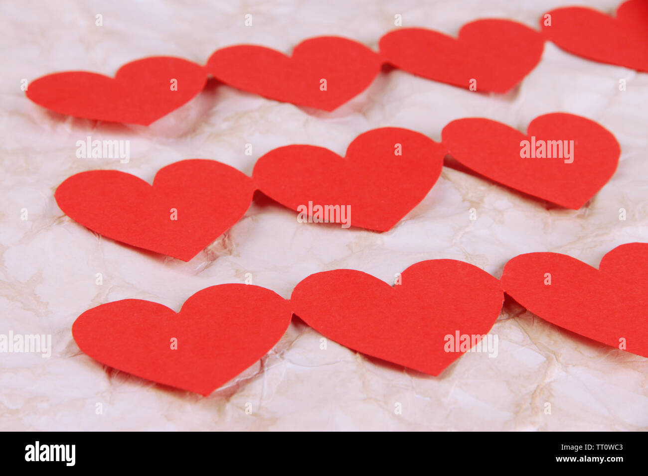 Paper hearts on paper background Stock Photo - Alamy