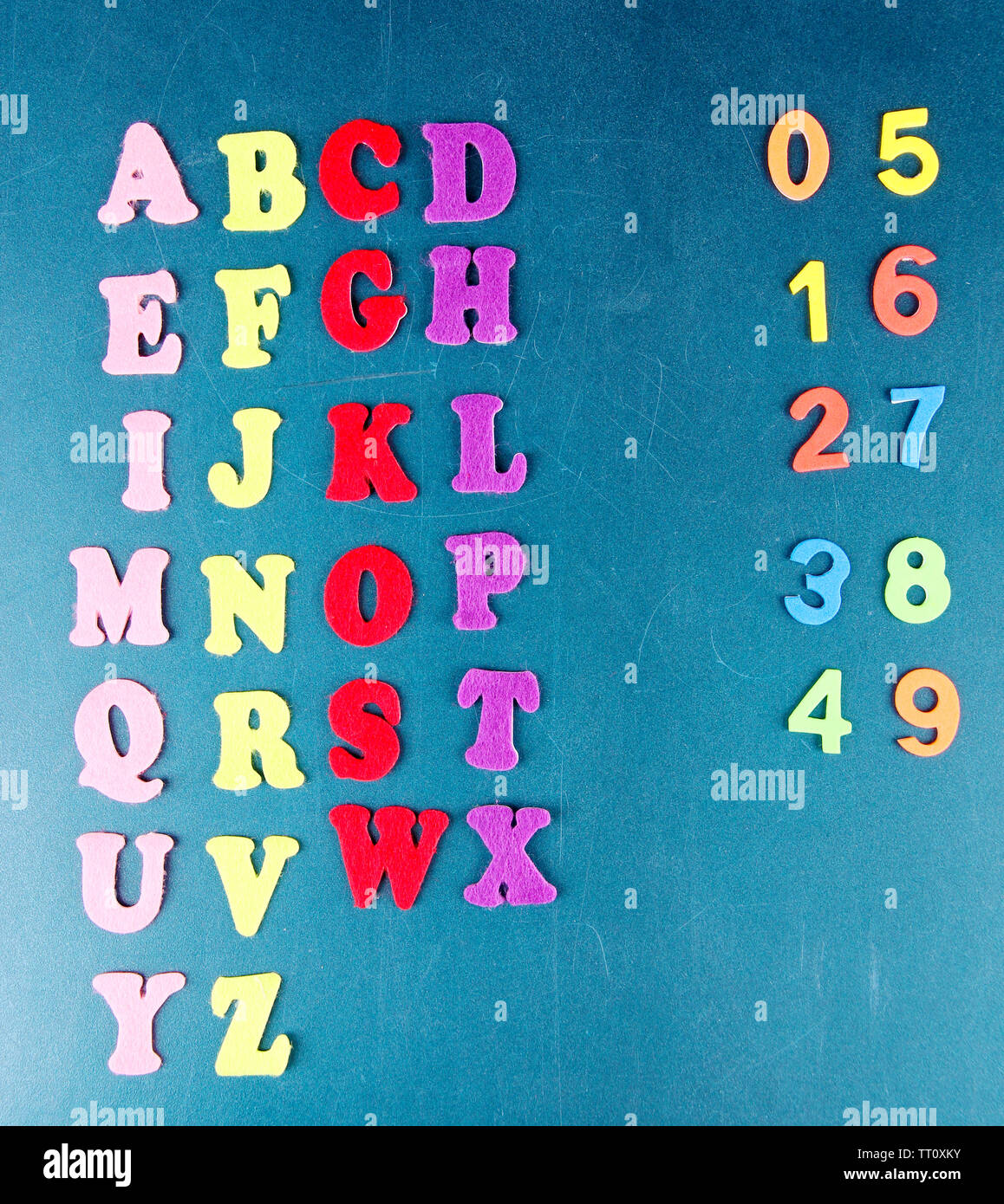 English alphabet and numbers on school desk background Stock Photo - Alamy