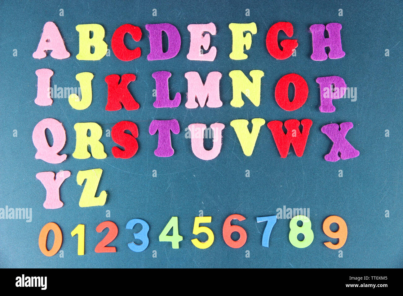 English alphabet and numbers on school desk background Stock Photo - Alamy