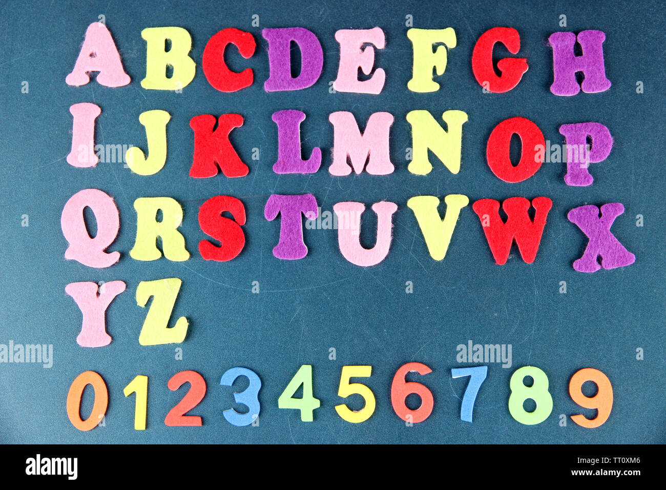 English alphabet and numbers on school desk background Stock Photo - Alamy