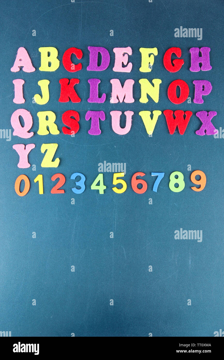 English alphabet and numbers on school desk background Stock Photo - Alamy