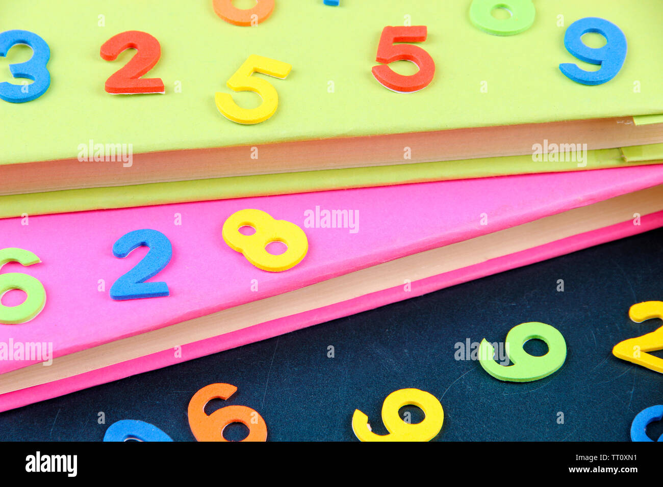 Colorful numbers and books on school desk background Stock Photo - Alamy