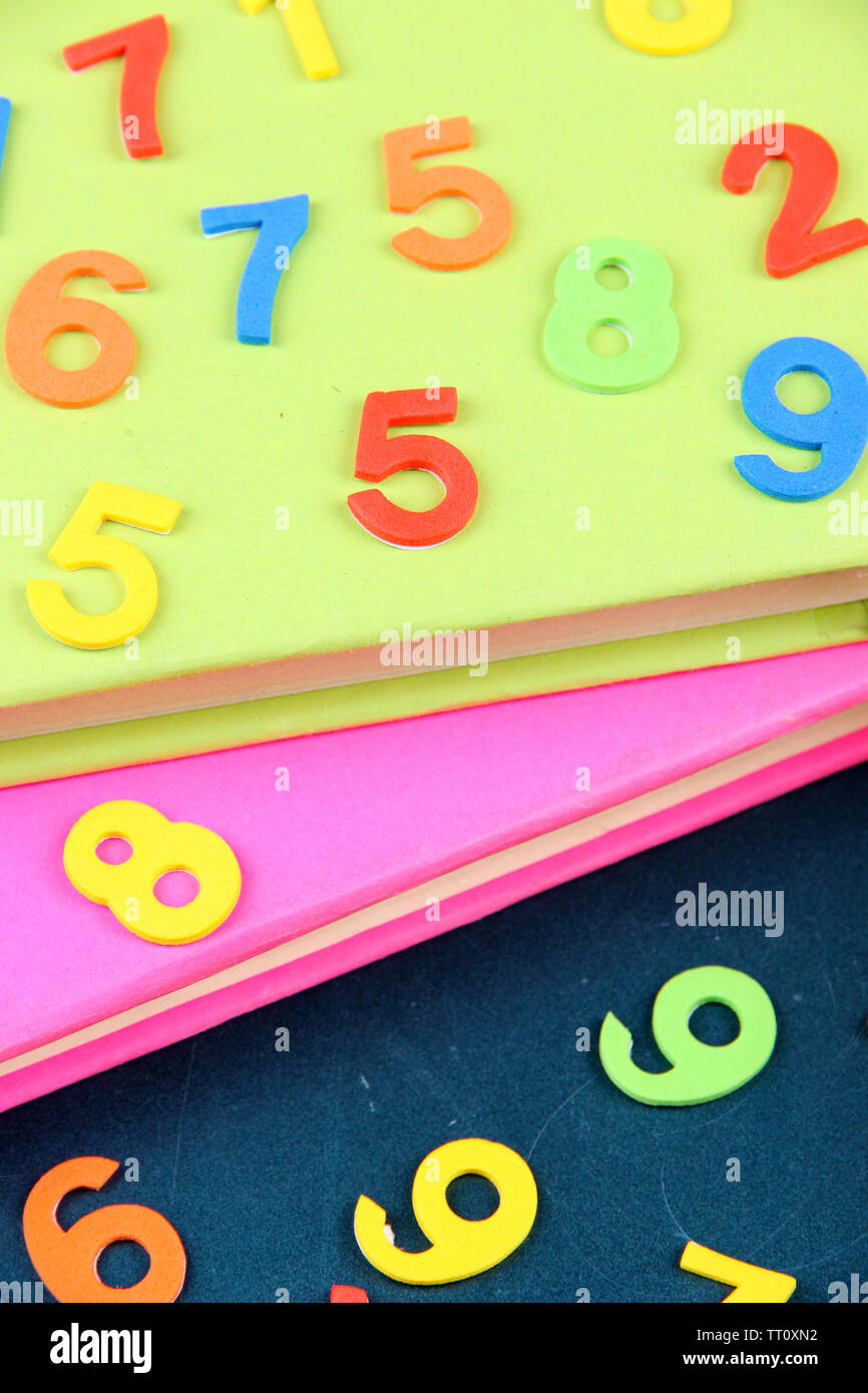 Colorful numbers and books on school desk background Stock Photo - Alamy