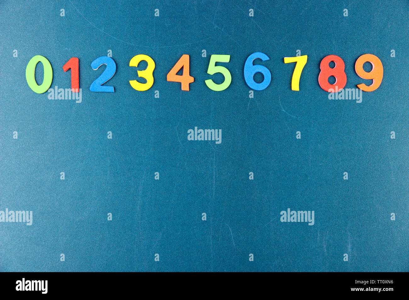 Colorful numbers on school desk background Stock Photo - Alamy
