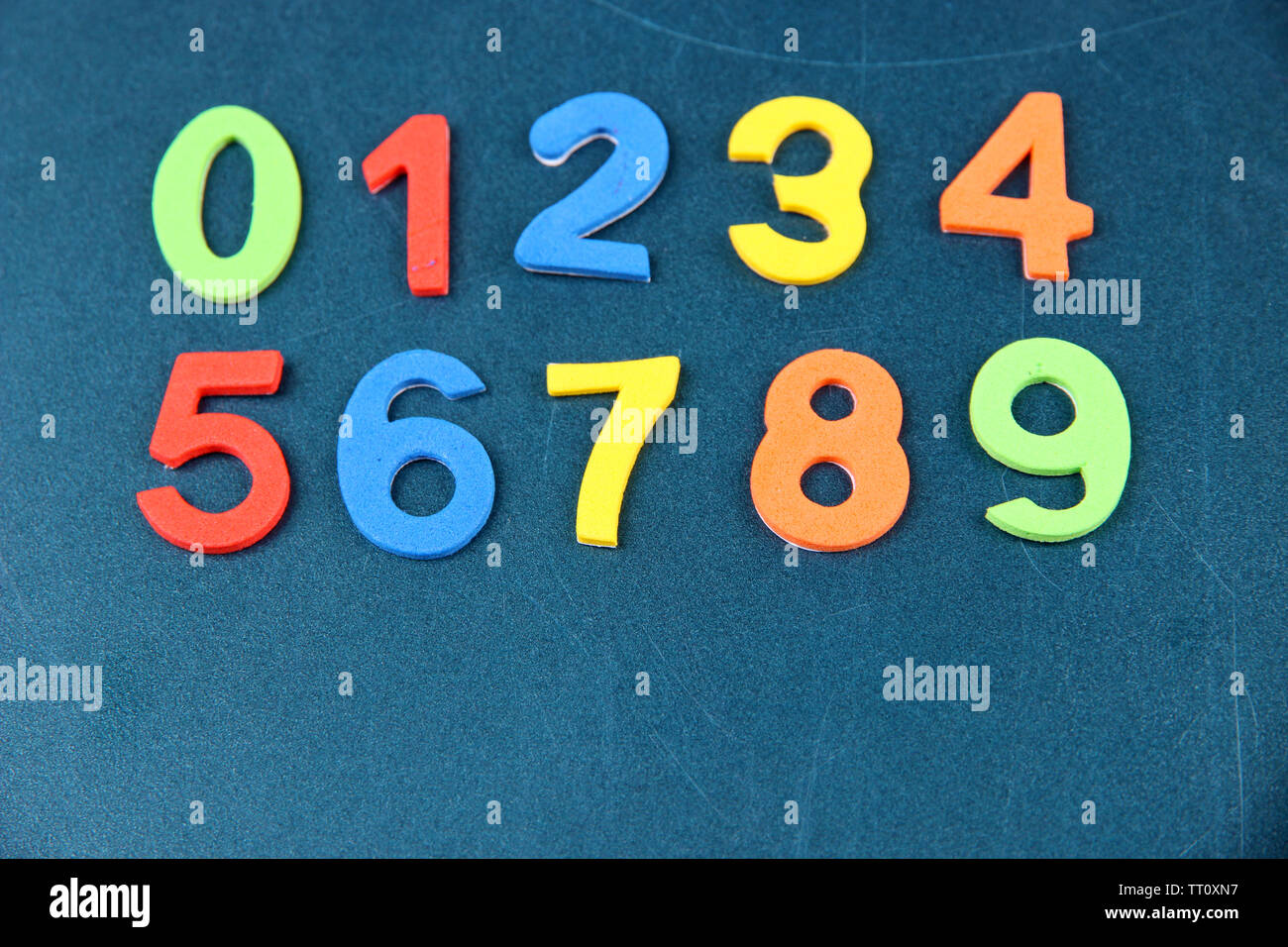 Colorful numbers on school desk background Stock Photo - Alamy