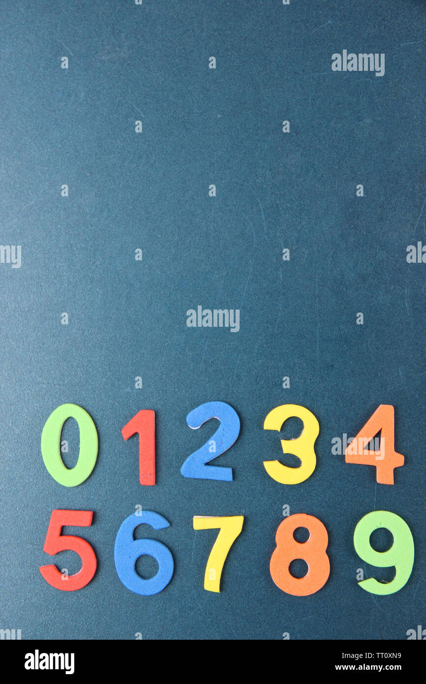 Colorful numbers on school desk background Stock Photo - Alamy