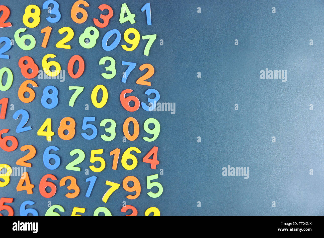Colorful numbers on school desk background Stock Photo - Alamy