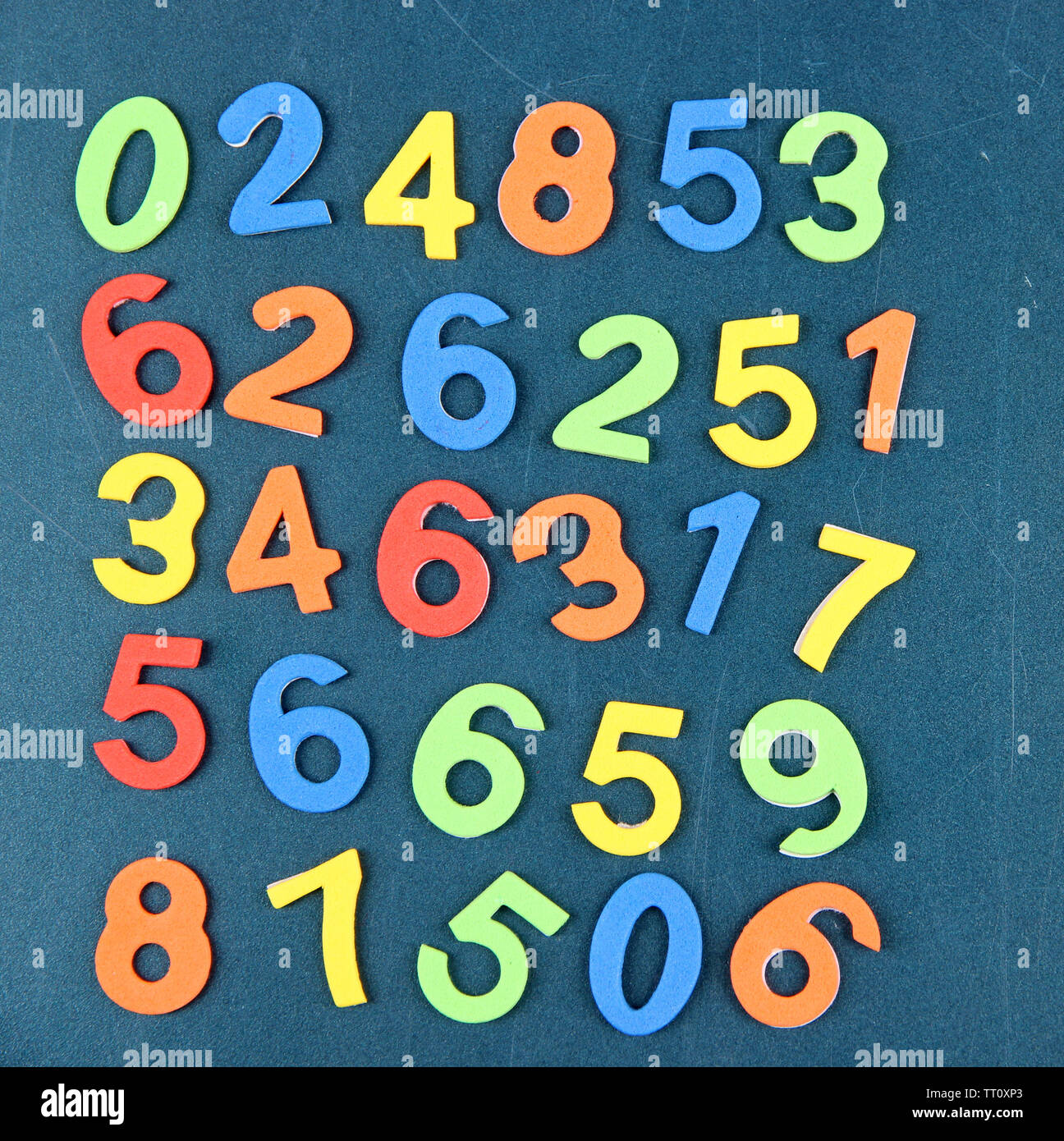 Colorful numbers on school desk background Stock Photo - Alamy