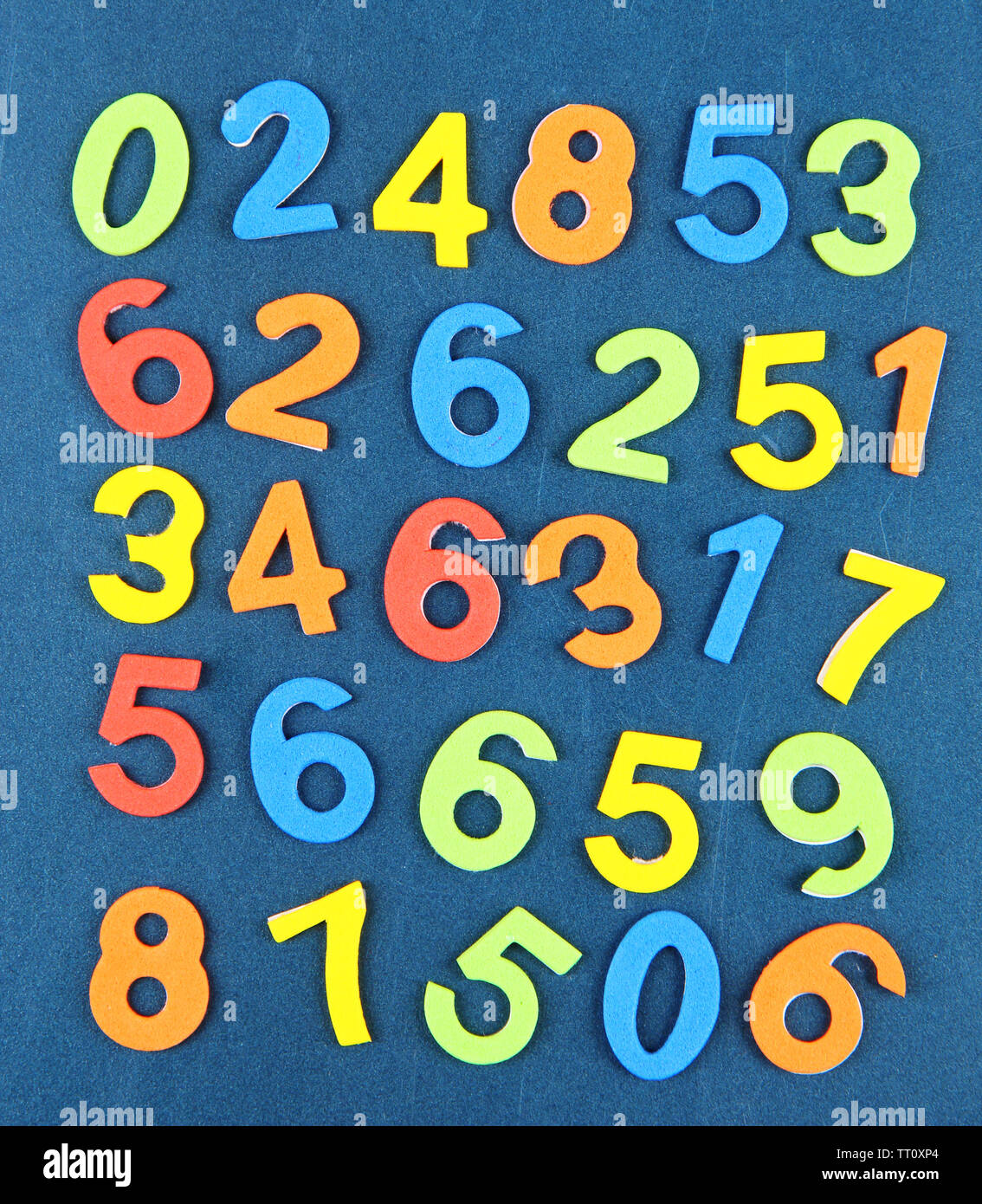 Colorful numbers on school desk background Stock Photo - Alamy